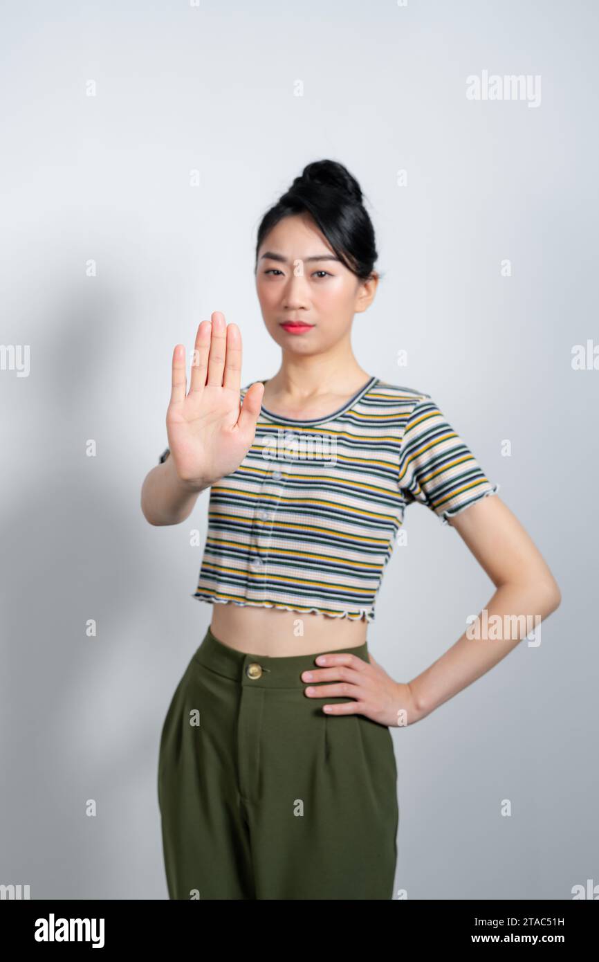 asian young woman looking serious, stern, displeased and angry showing ...