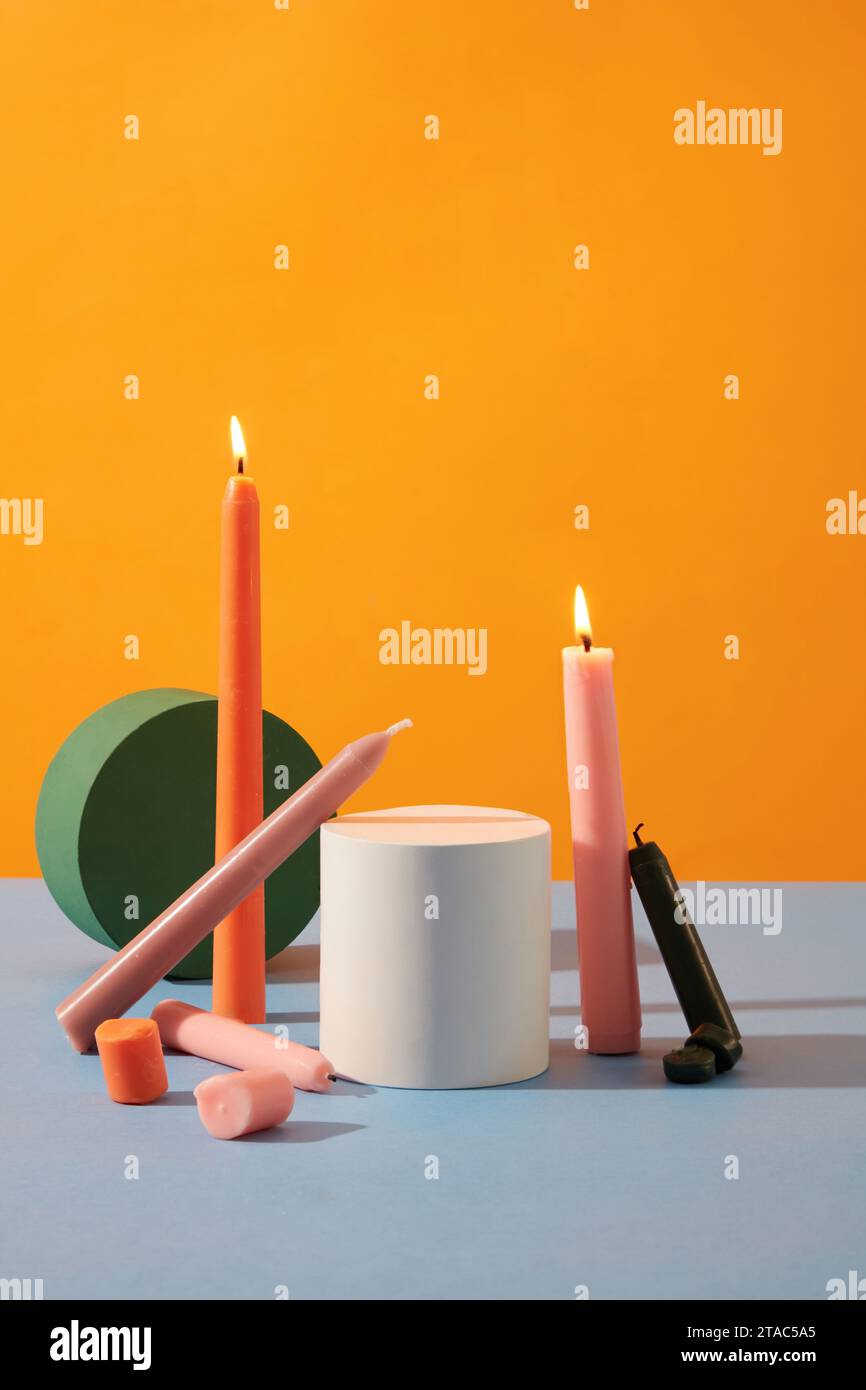 Front view of colored candles and round wooden platforms are displayed ...