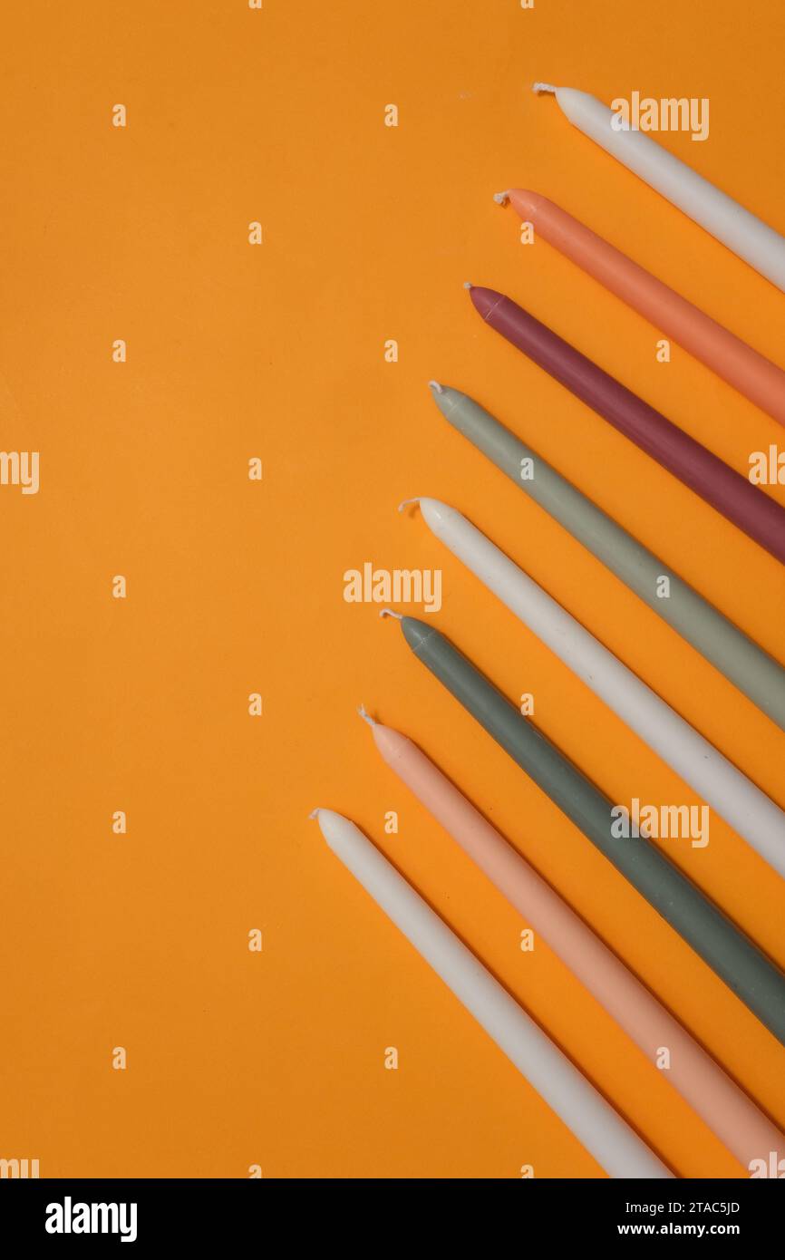 Straight candles of different colors are arranged evenly on the right ...