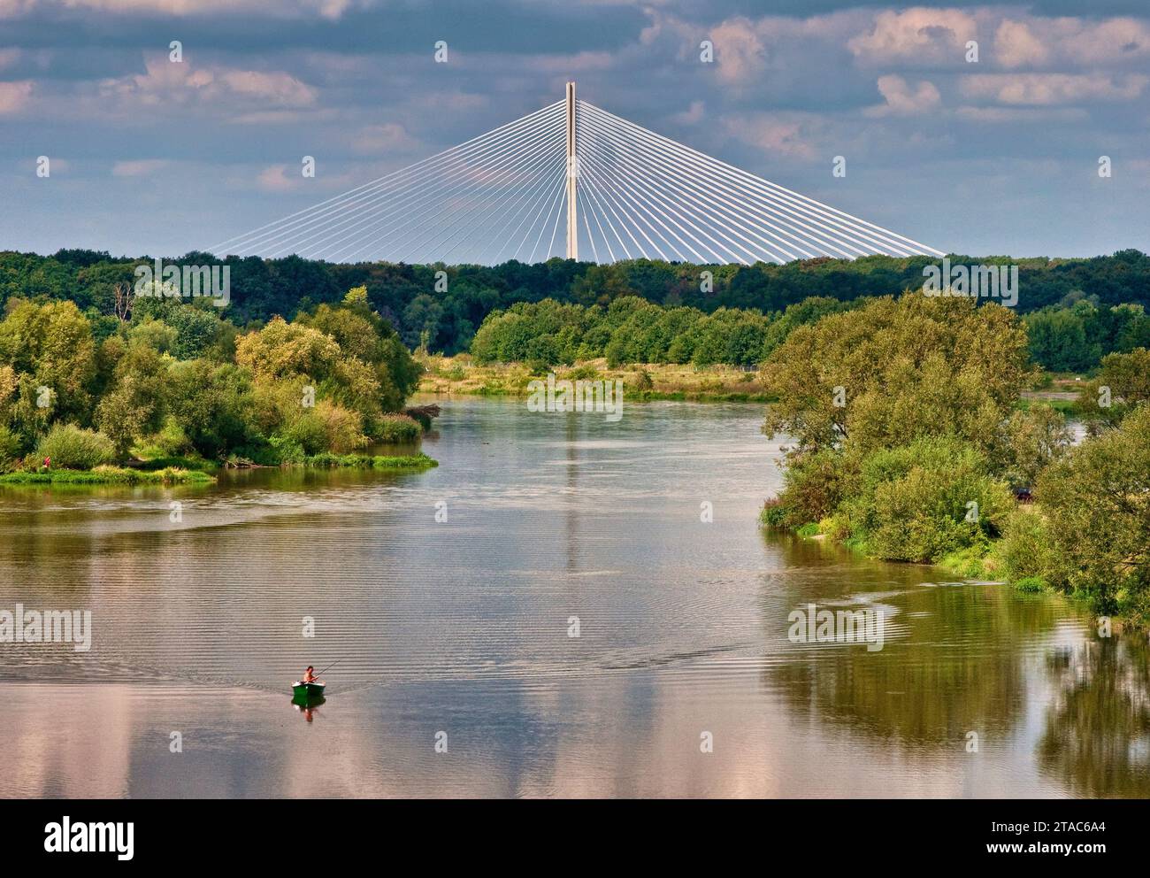 Angler at boat on Oder River, with Redzinski Bridge in dist, the world ...
