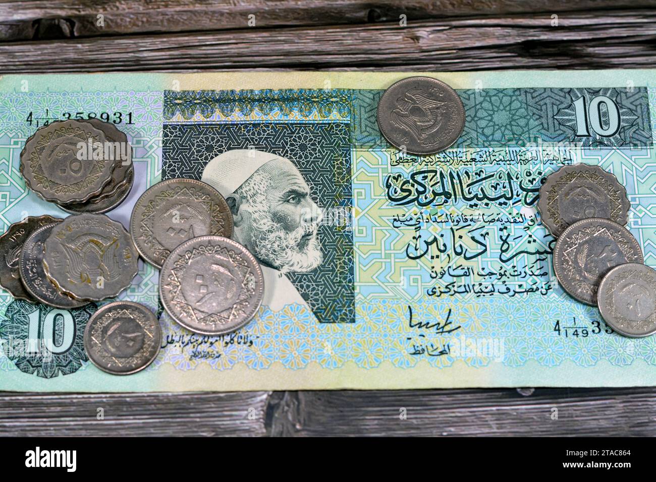 Background of old Libyan money banknote bills and coins of different ...
