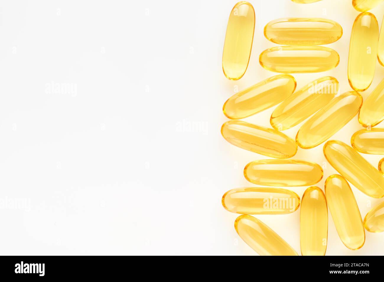 Capsules. Yellow pills isolated on white. Close up capsules with ...