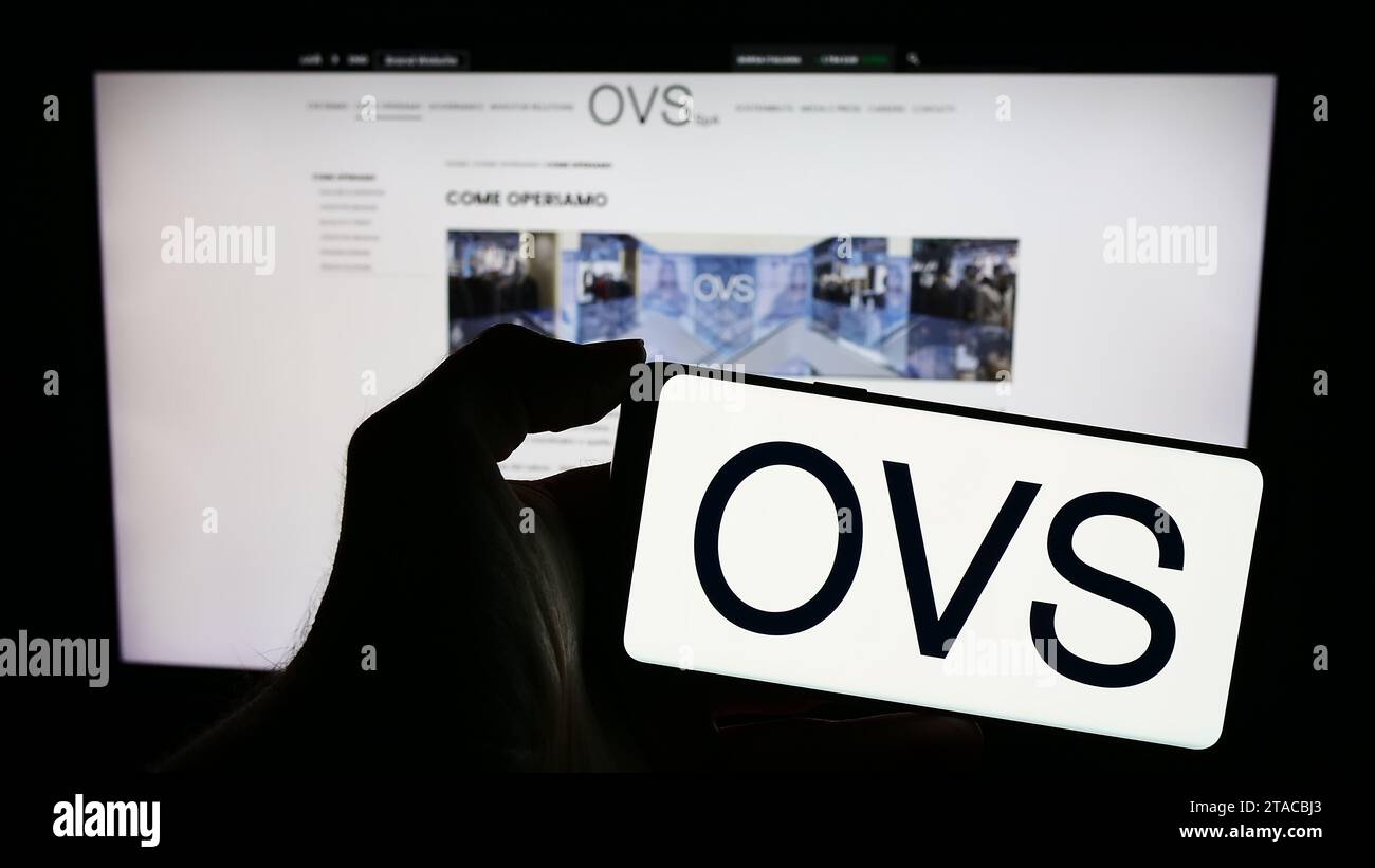Person holding smartphone with logo of Italian fashion company OVS S.p ...