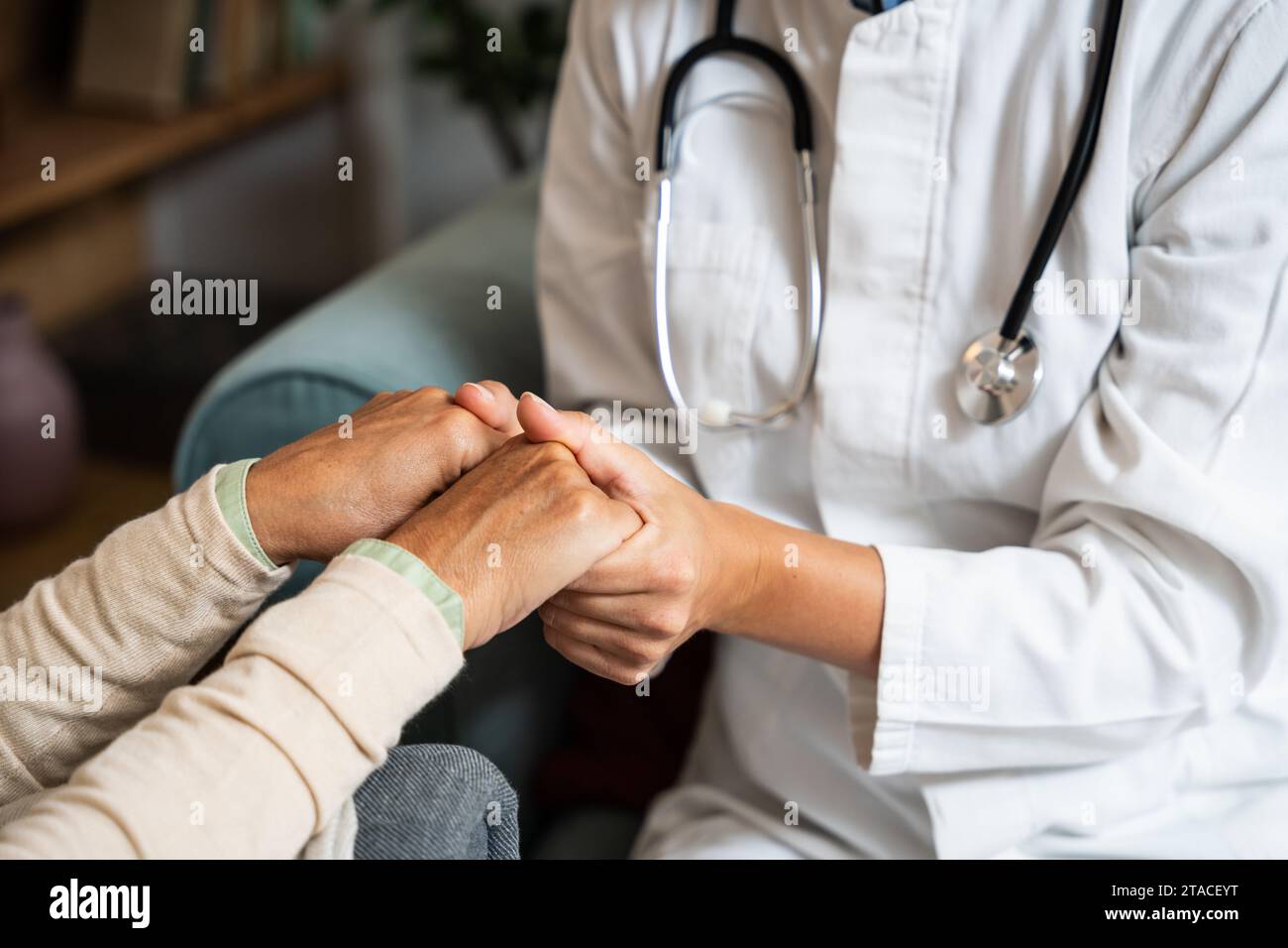 Close up of supportive female caregiver hold hand of mature grandmother ...