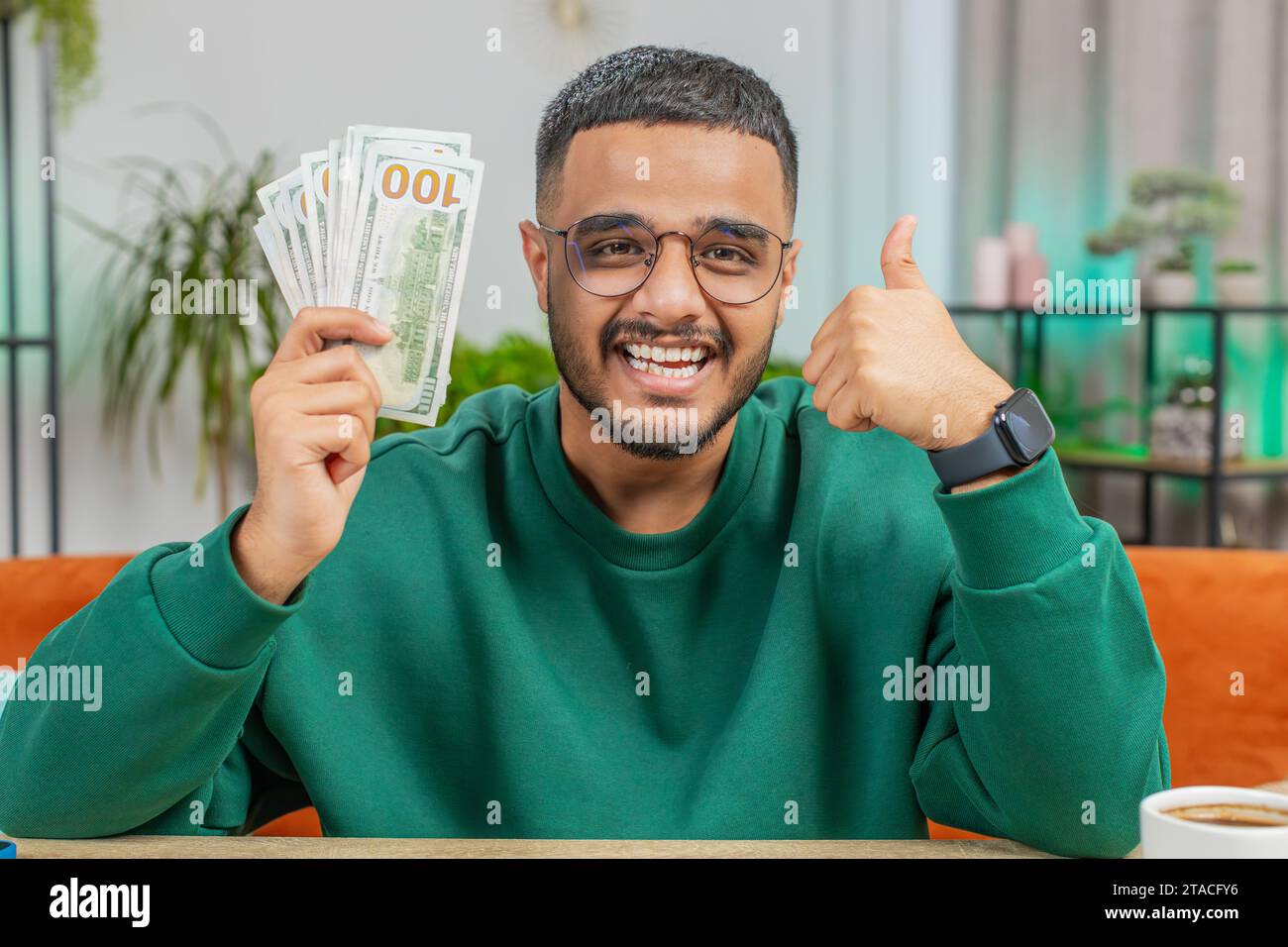 Planning budget. Rich happy Indian man counting money cash calculate ...