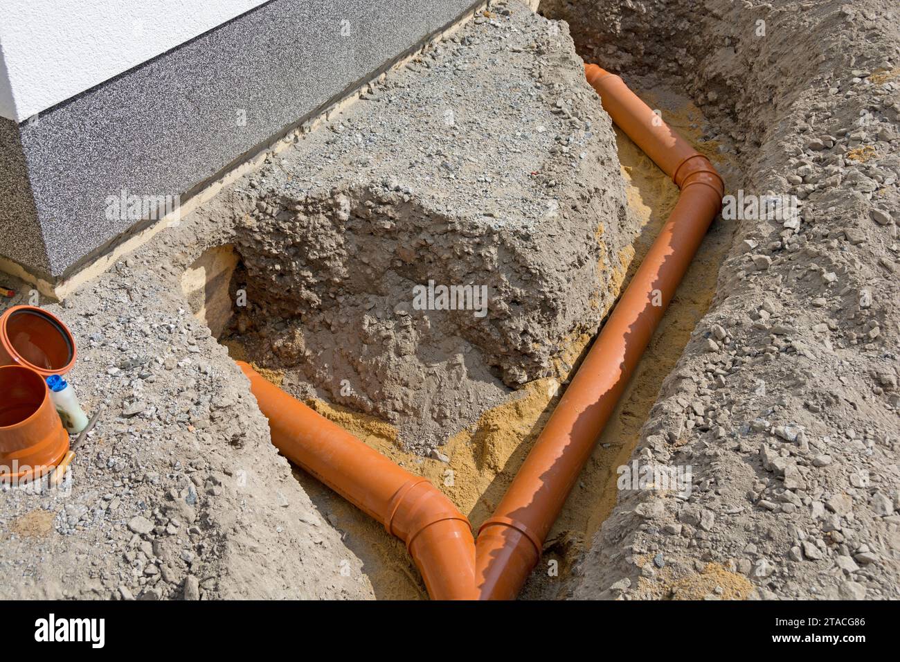 Open ditch with laid sewage pipes on residential building Stock Photo ...