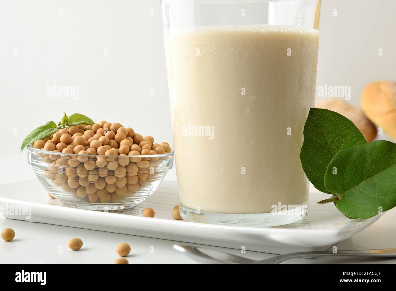 Detail of breakfast with milk and soy bread on white table with bowl ...