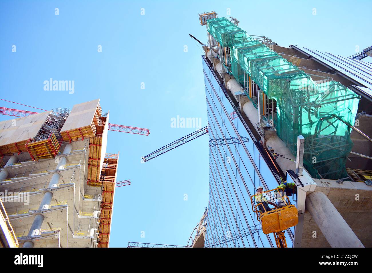 High rise building under construction. Installation of glass facade ...