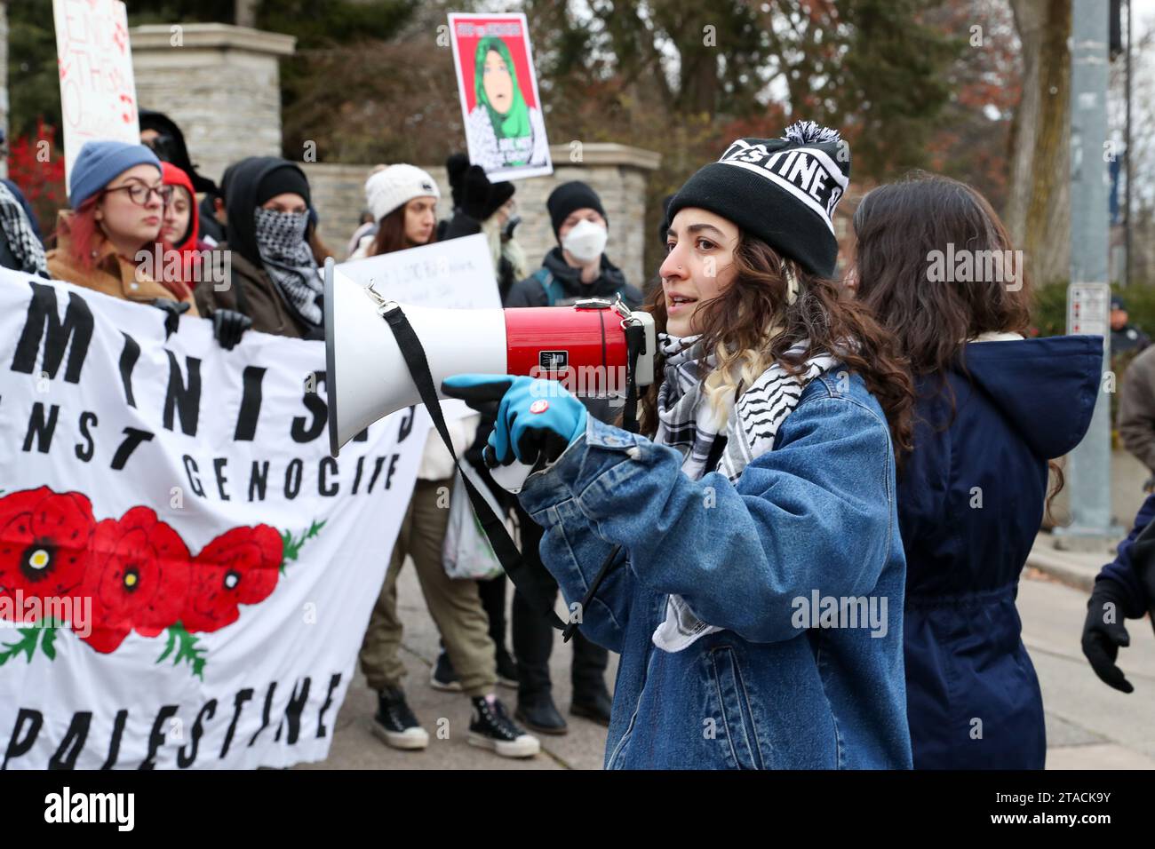 State College, United States. 29th Nov, 2023. A woman uses a bullhorn ...
