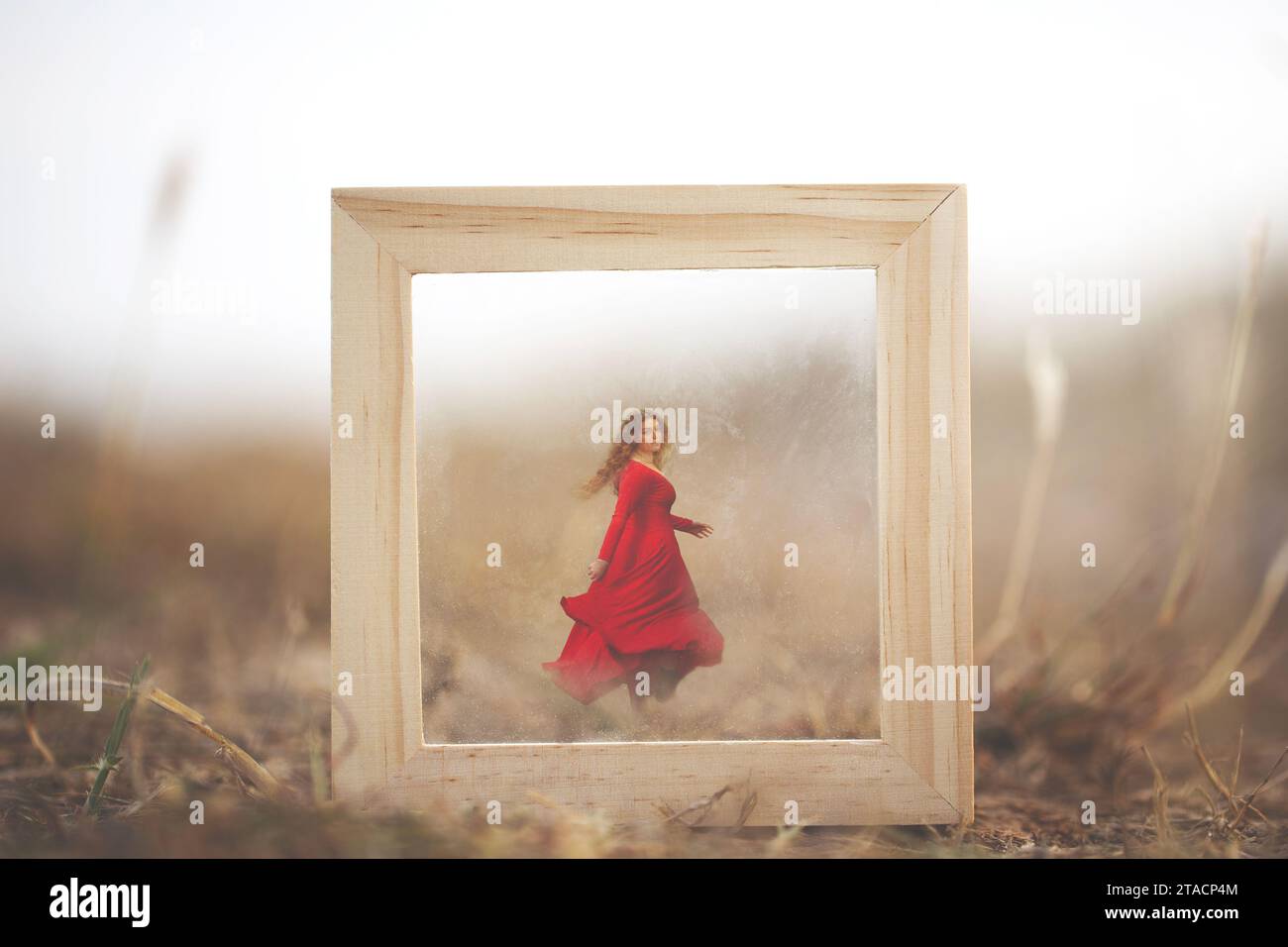 woman dressed in red running away through a surreal frame in the middle ...