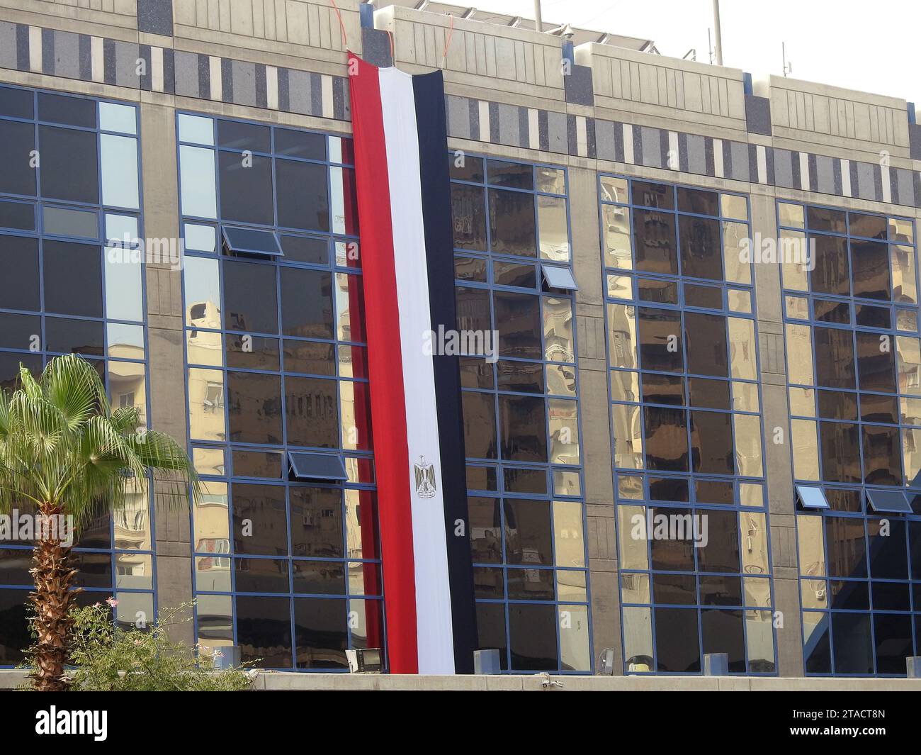 A blue building with the Egyptian flag across the building height ...