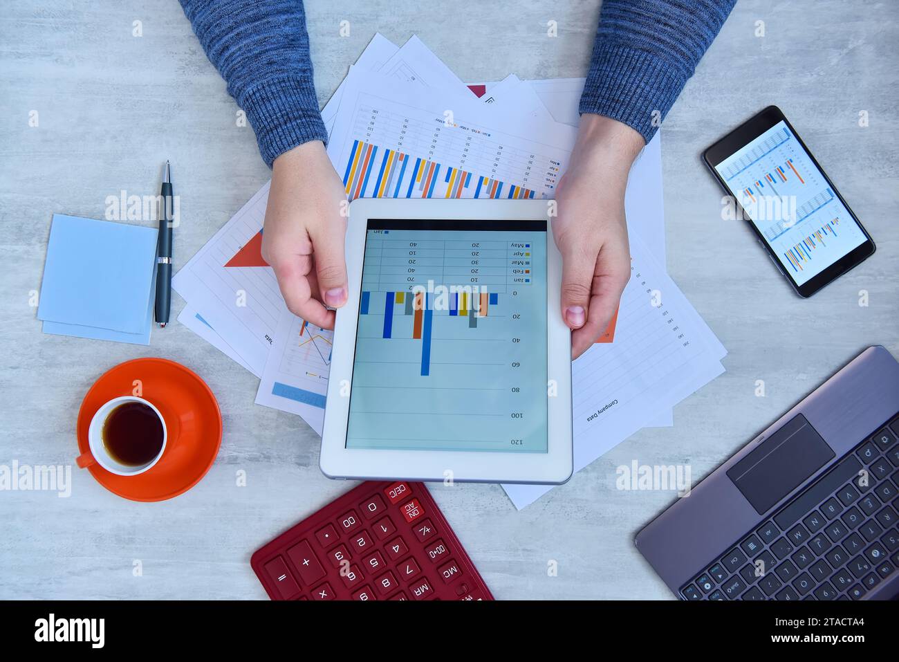 Businessman hands using tablet computer with stock market data. Money ...