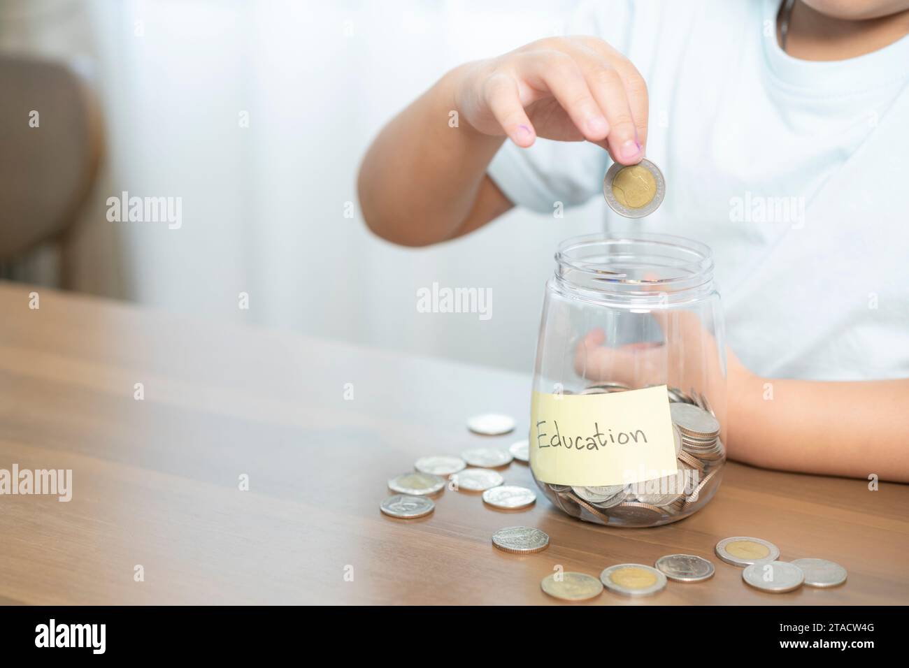The girl is saving money for her education Stock Photo - Alamy