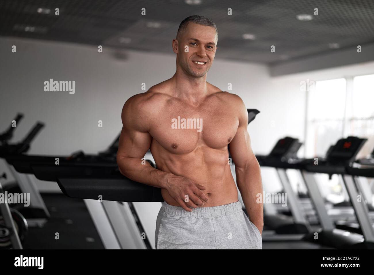Muscular athletic bodybuilder fitness model standing gym Sport fitness ...