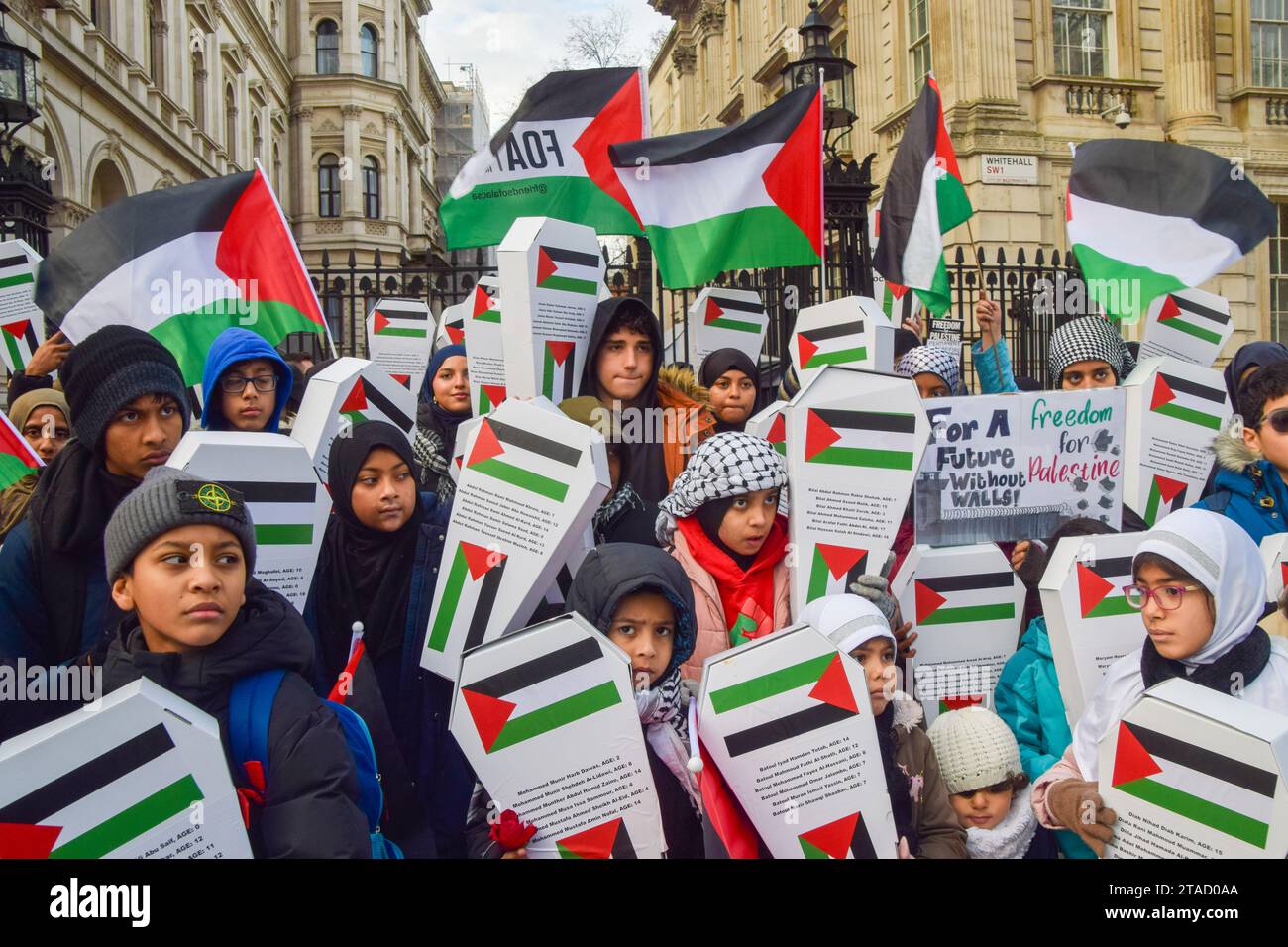 London, England, UK. 30th Nov, 2023. Children hold cardboard "child ...