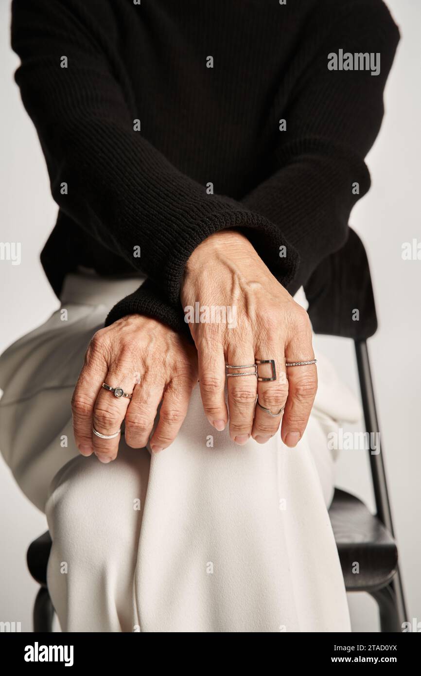 cropped middle aged business woman in smart casual attire and rings on ...