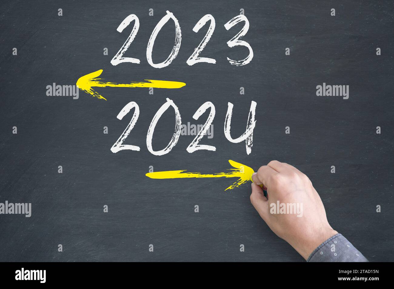 Close-up of human hand drawing old Year 2023 and New Year 2024 with ...