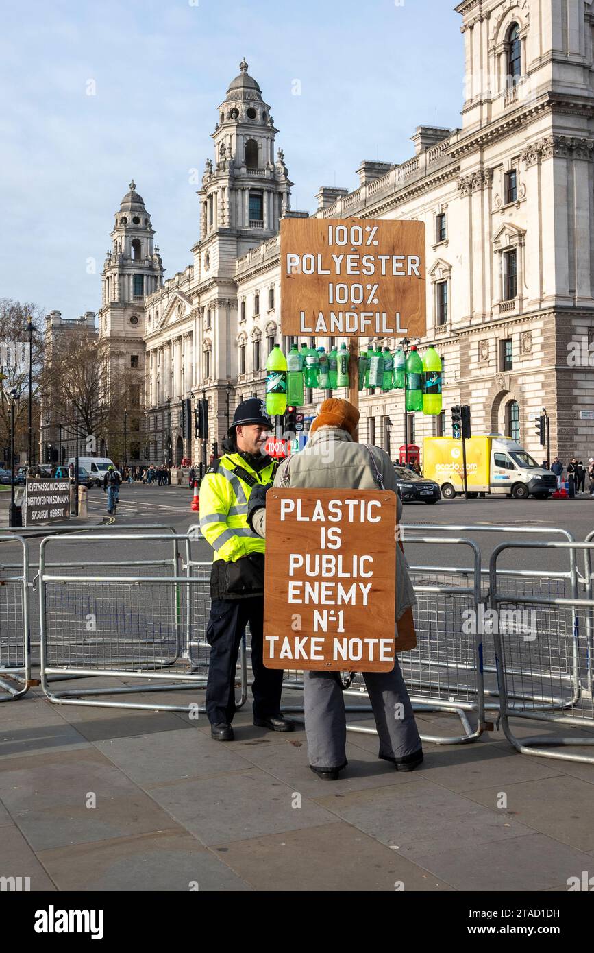 Protestor against plastic pollution with police officer in Westminster ...