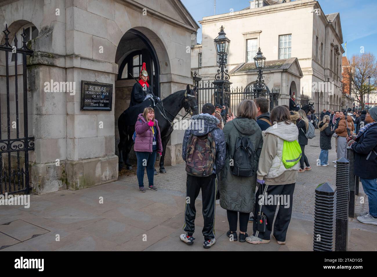 Tourists posing for photos with King's Life Guard, member of mounted ...