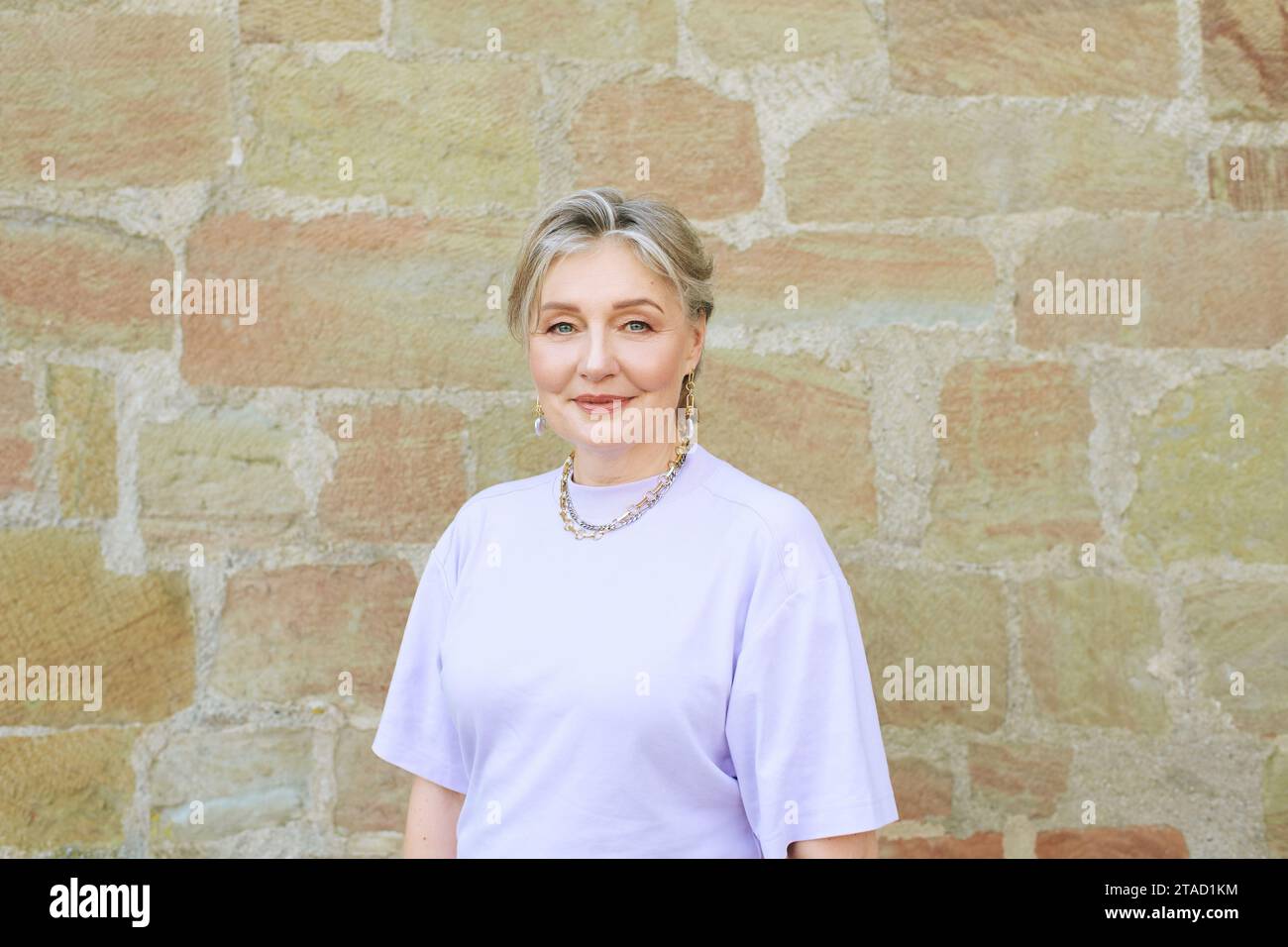 Outdoor portrait of pretty mature 50 - 55 year old woman with grey hair ...