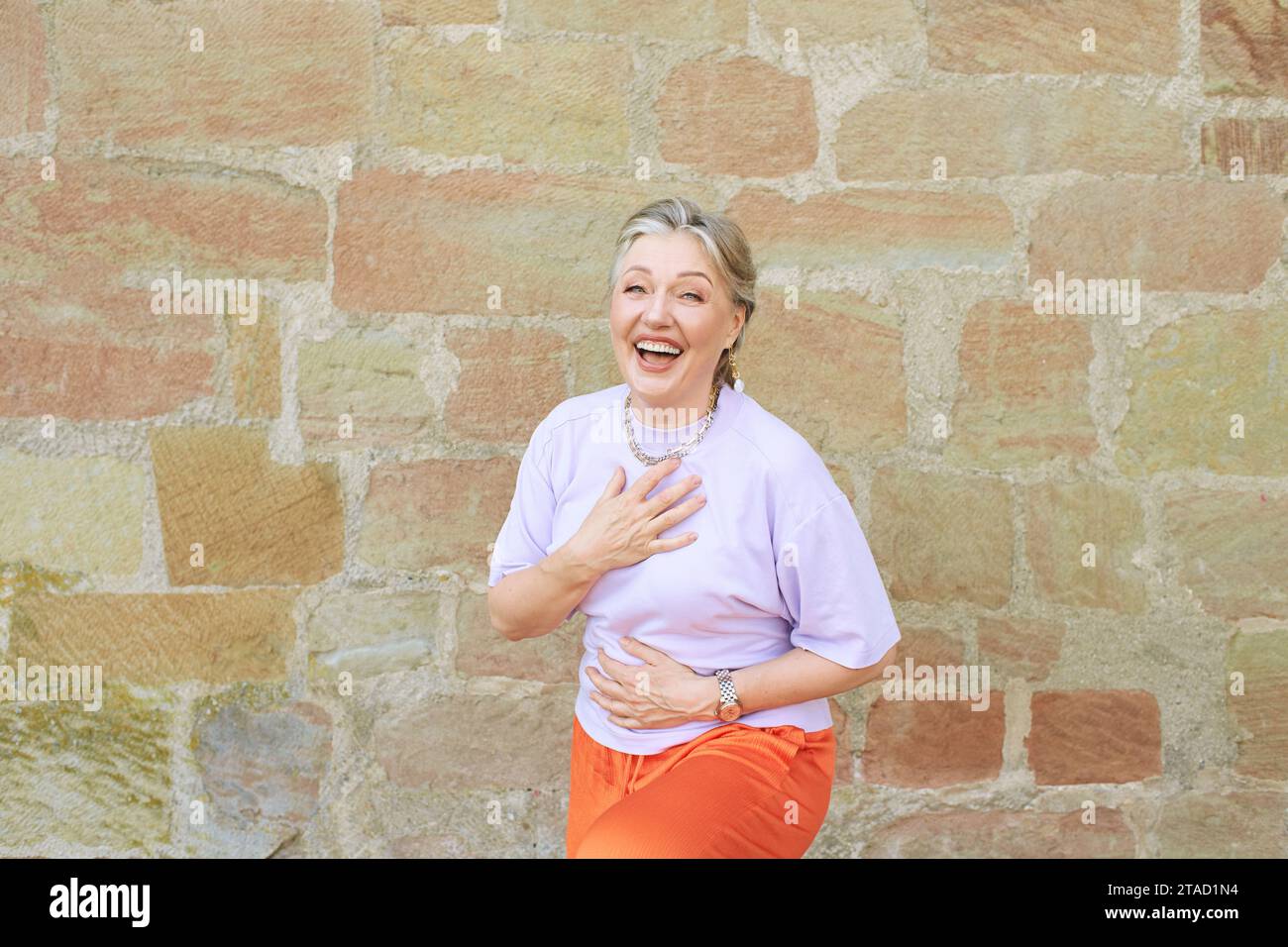 Outdoor portrait of happy laughing mature 50 - 55 year old woman with ...