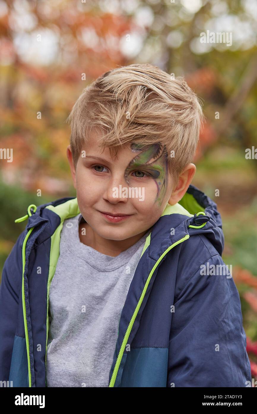 New Year 2024 masquerade - boy with dragon painting on his face. Symbol ...