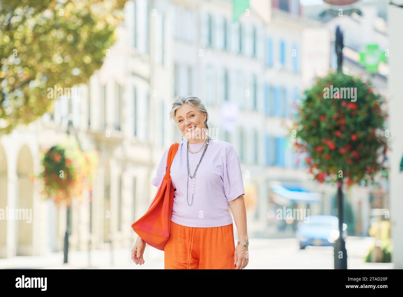 Outdoor fashion portrait of stylish mature 50 - 55 year old woman with ...