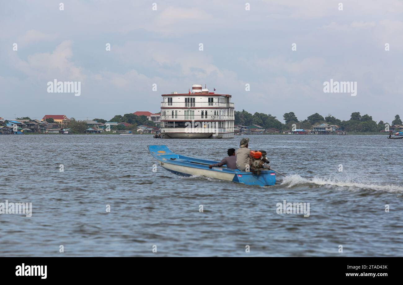 Local Khmer motor boat passing near luxury cruise ship The Jahan ...