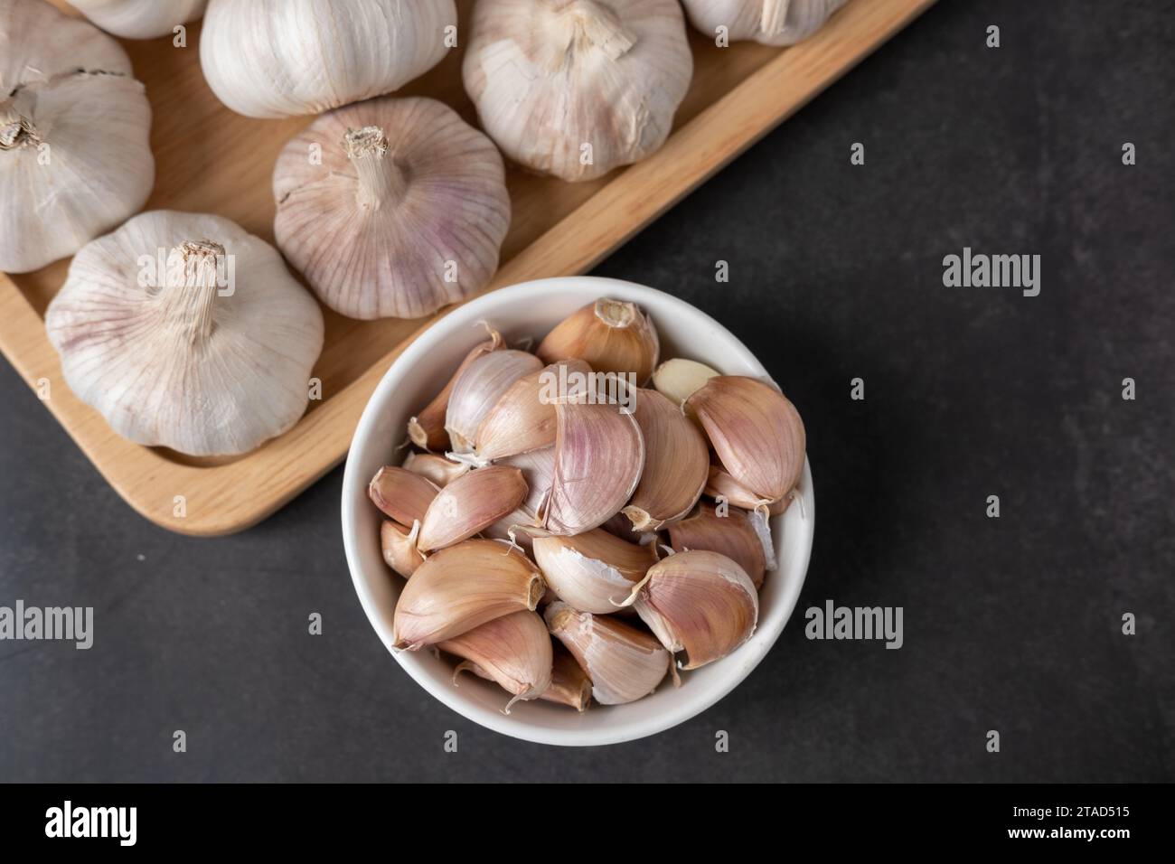 Big and small heads of garlic on a black background Stock Photo - Alamy