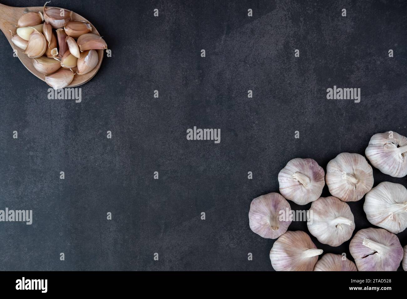 Big and small heads of garlic on a black background Stock Photo - Alamy