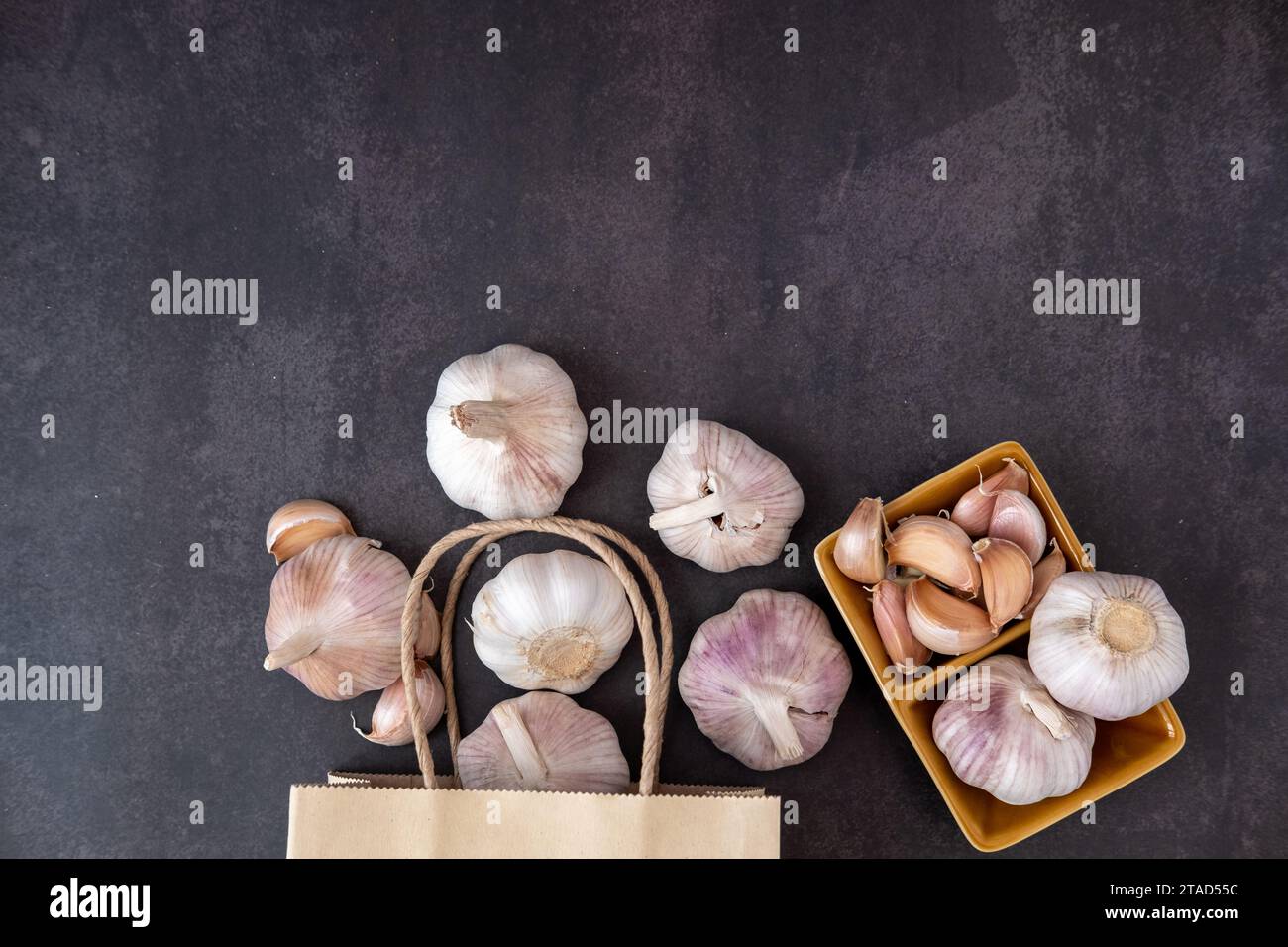 Big and small heads of garlic on a black background Stock Photo - Alamy