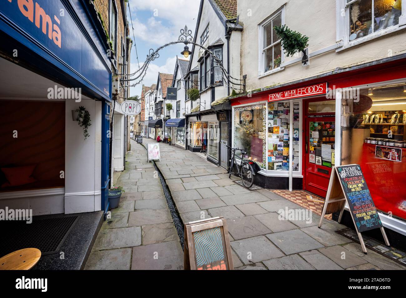 Shops and cafes in historic Cheap Street in Frome, Somerset, UK on 30 ...