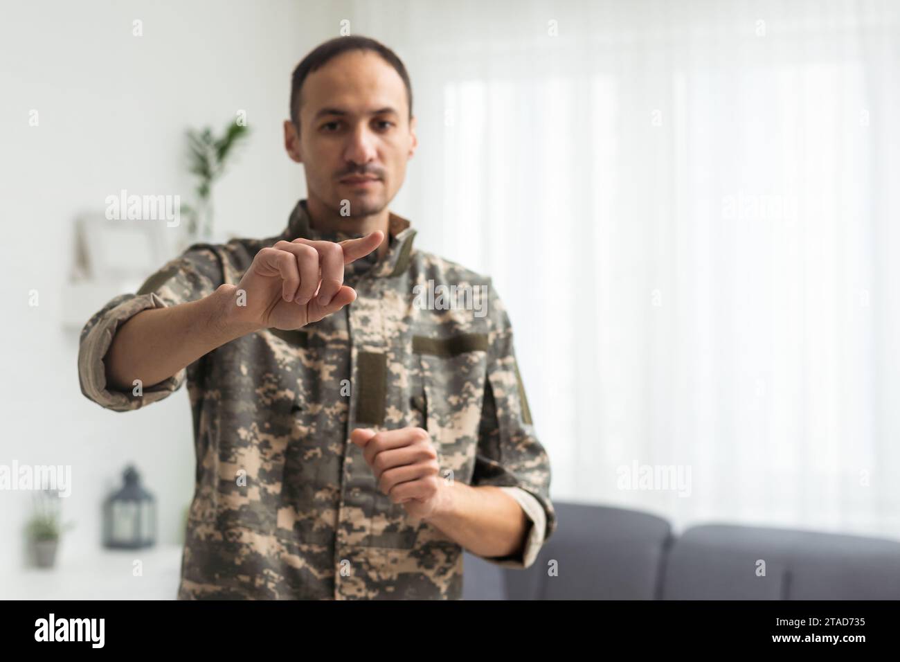 Confident masculine military man looking and pointing finger at camera ...