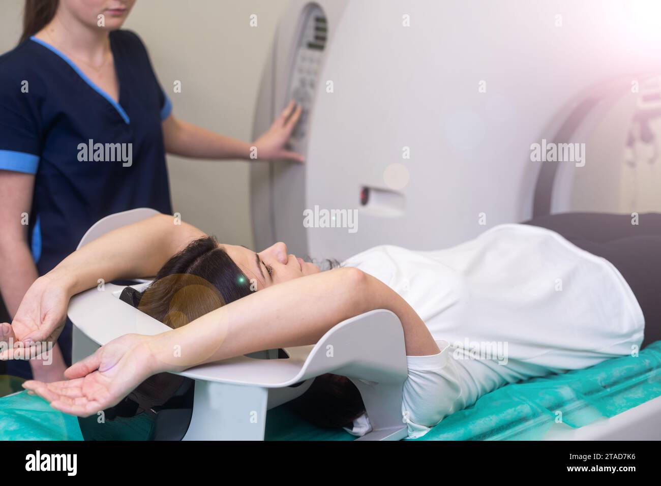 Radiologic technician and Patient being scanned and diagnosed on computed tomography scanner in ...