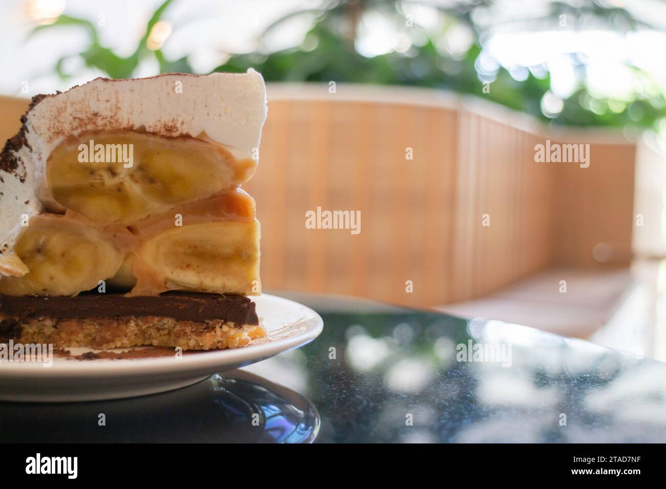 Banoffee cake with bananas and whipped cream in cafe restaurant, stock ...