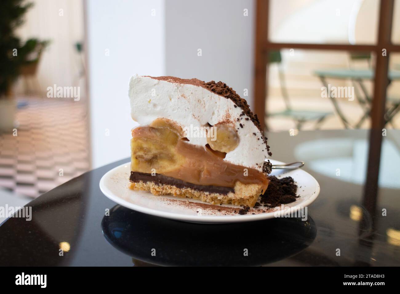 Banoffee cake with bananas and whipped cream in cafe restaurant, stock ...