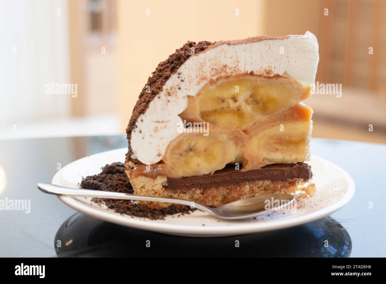 Banoffee cake with bananas and whipped cream in cafe restaurant, stock ...
