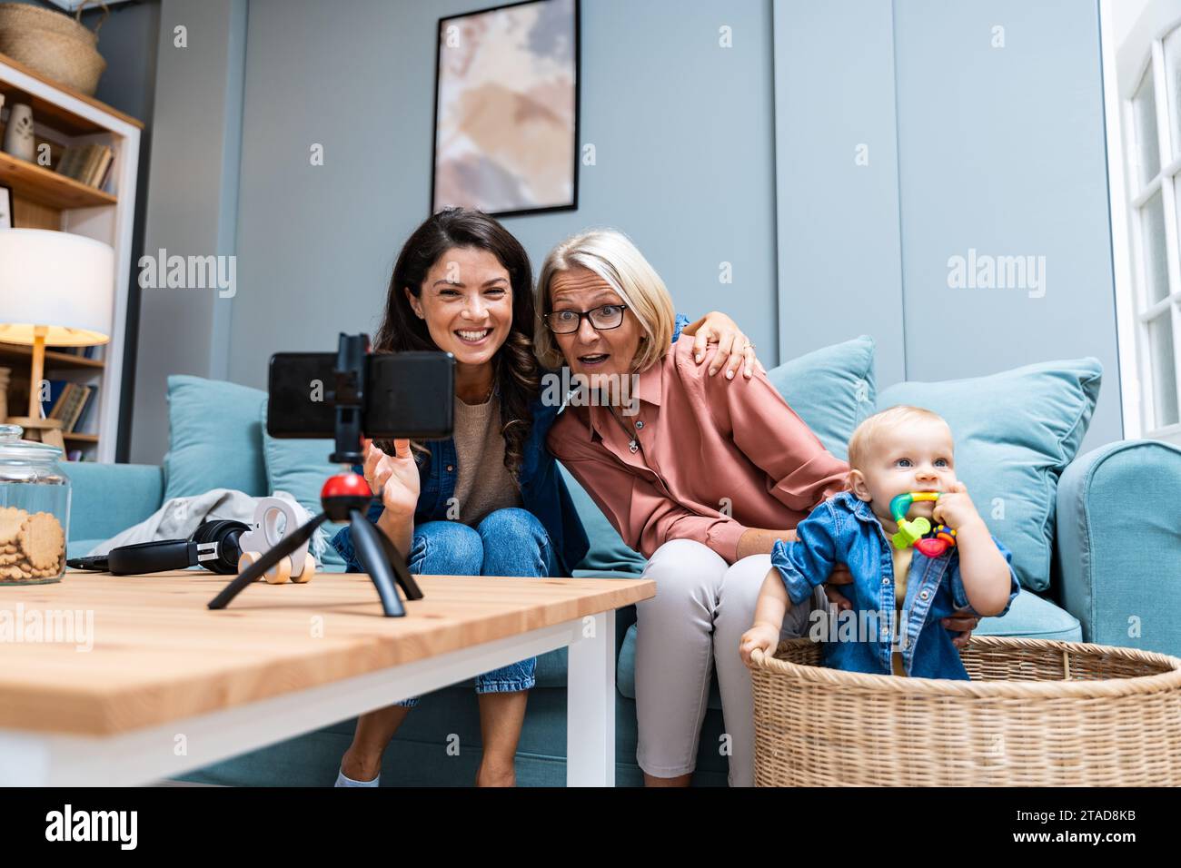 Mother baby and grandmother talking on video call on smart phone in the ...