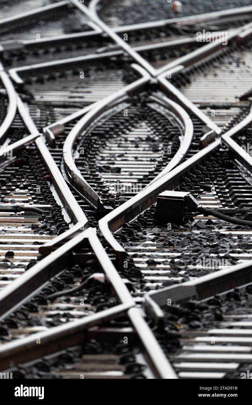 A collection of railway lines sit side by side in a neat row, all ...