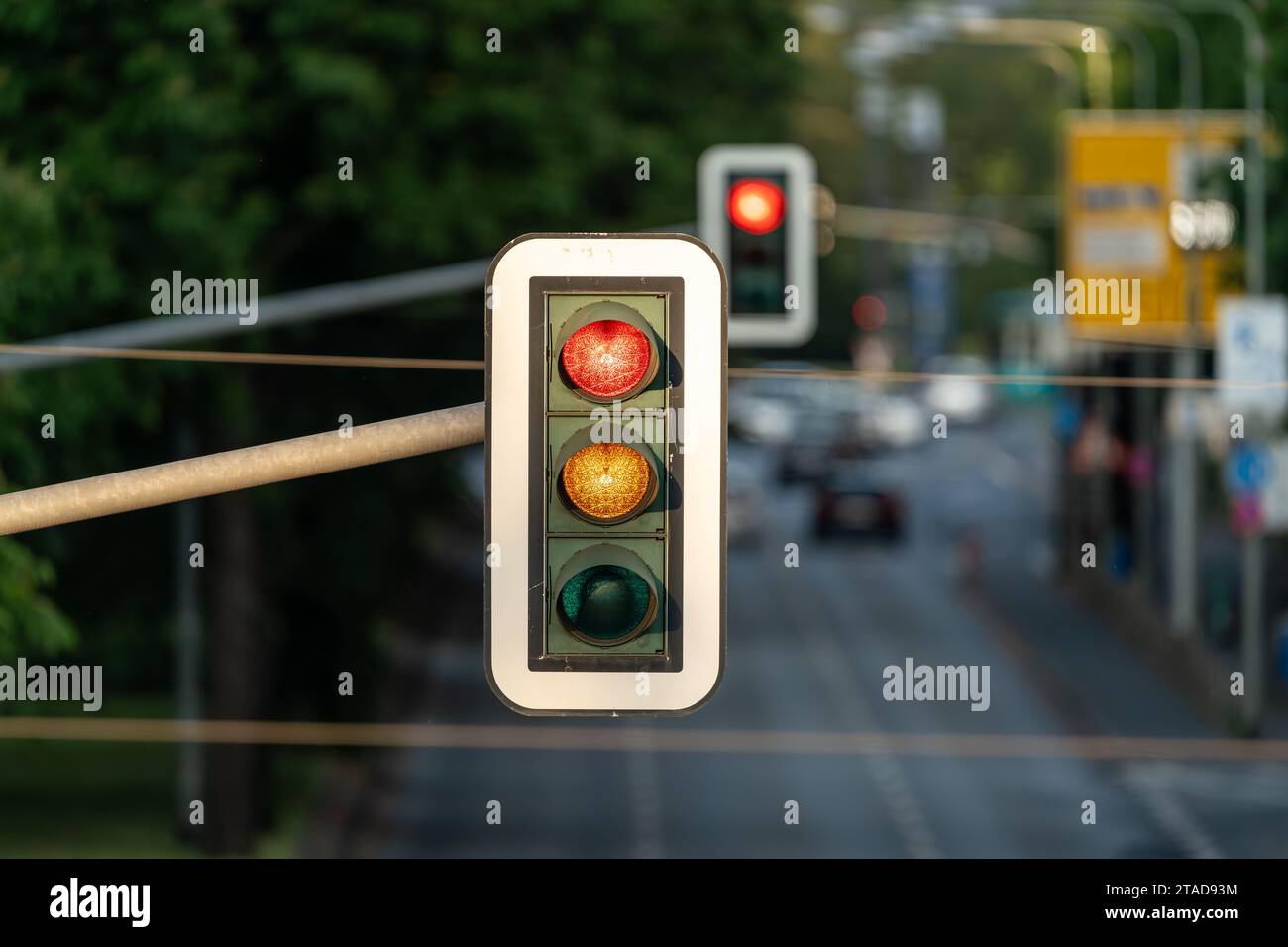 Three red, yellow and green traffic lights are set up on the side of a ...