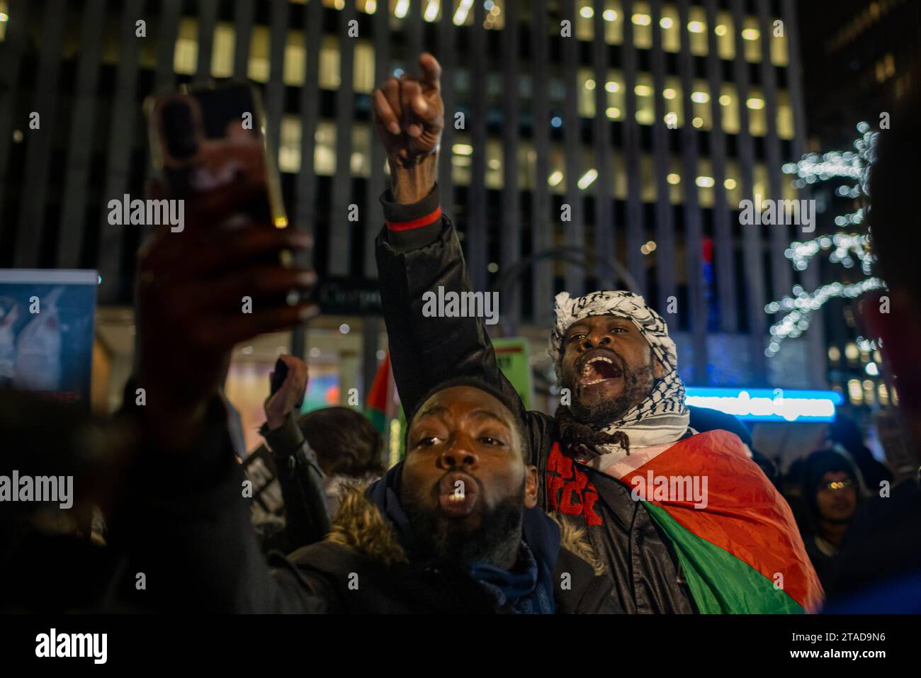 NEW YORK, NEW YORK - NOVEMBER 29: Pro-Palistine protesters jeer NYPD ...