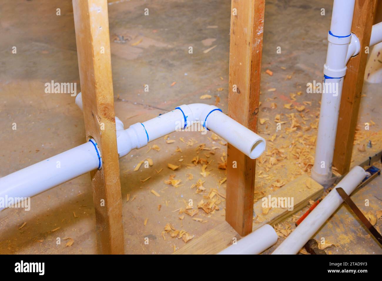 Installing drainage PVC pipe system in new house construction in wall ...