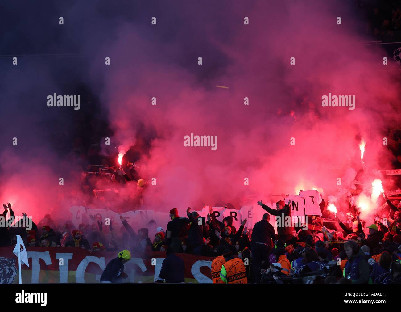 London, UK. 29th Nov, 2023. RC Lens fans set off a flare during the ...