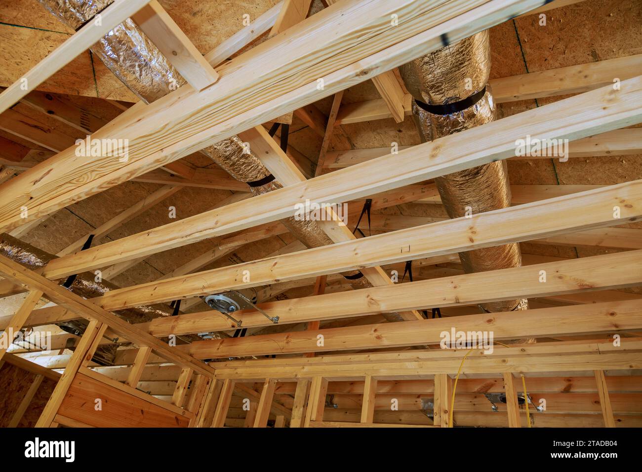 Skeletal construction interior view of new house under wooden framing ...