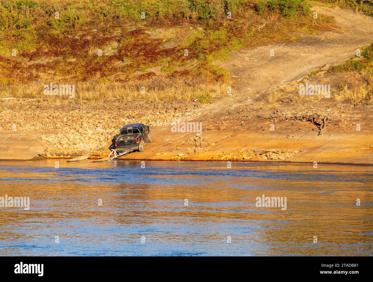 Truck and boat trailer by water's edge of Mississippi river in extreme ...