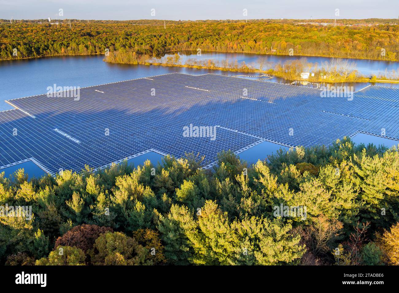 An array of solar panels floating in water large pond generating ...