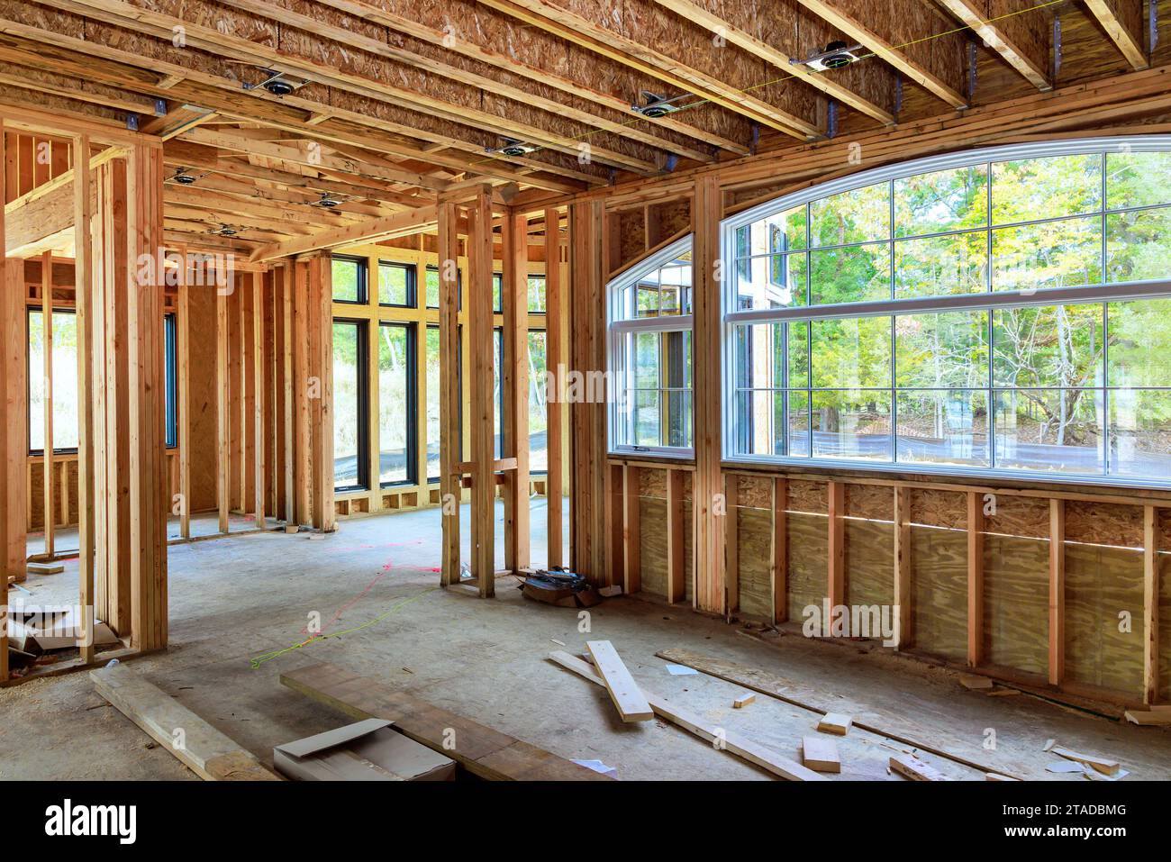 Construction of new house in building area featuring unfinished framing ...