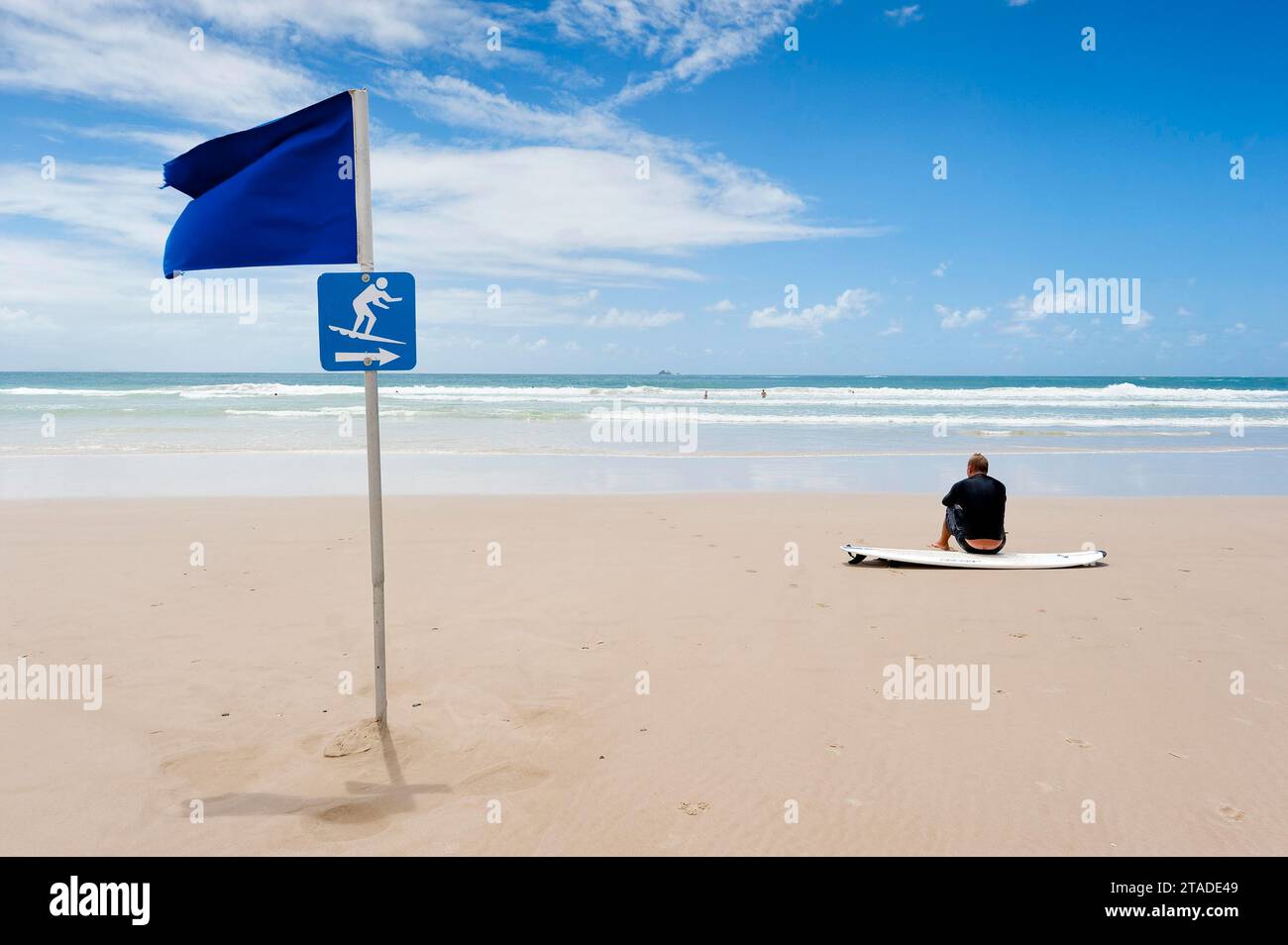 Surfer waiting, waiting, time, for the right wave on the beach of Byron ...