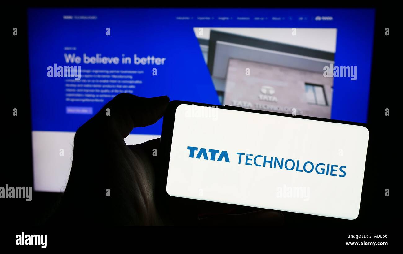 Person holding mobile phone with logo of Indian engineering company ...