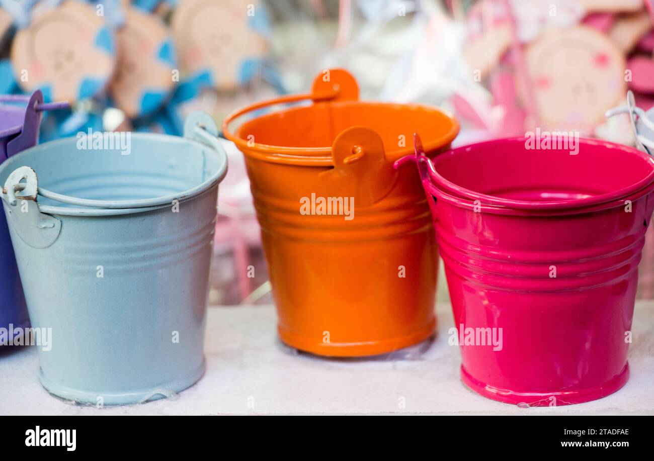 Little set of buckets of various colors in a market place Stock Photo ...